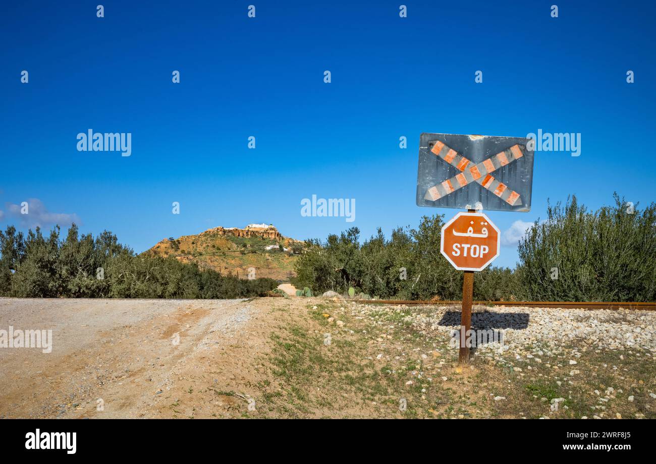 A Tunisian railway crossing with the ancient hilltop Berber village of ...