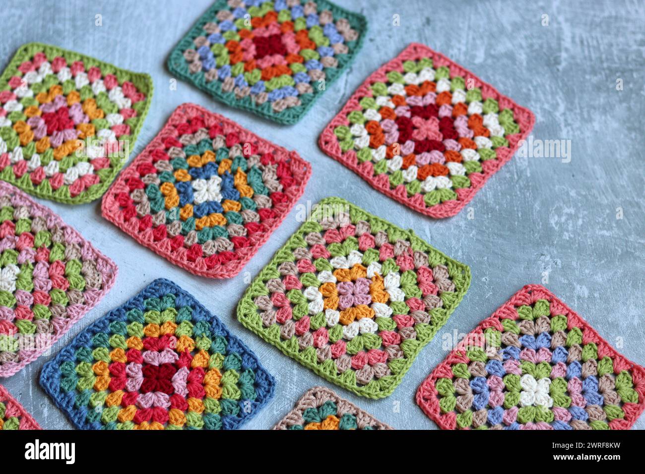 Handmade crocheting, needlework and handicraft concept. Rainbow colored ...