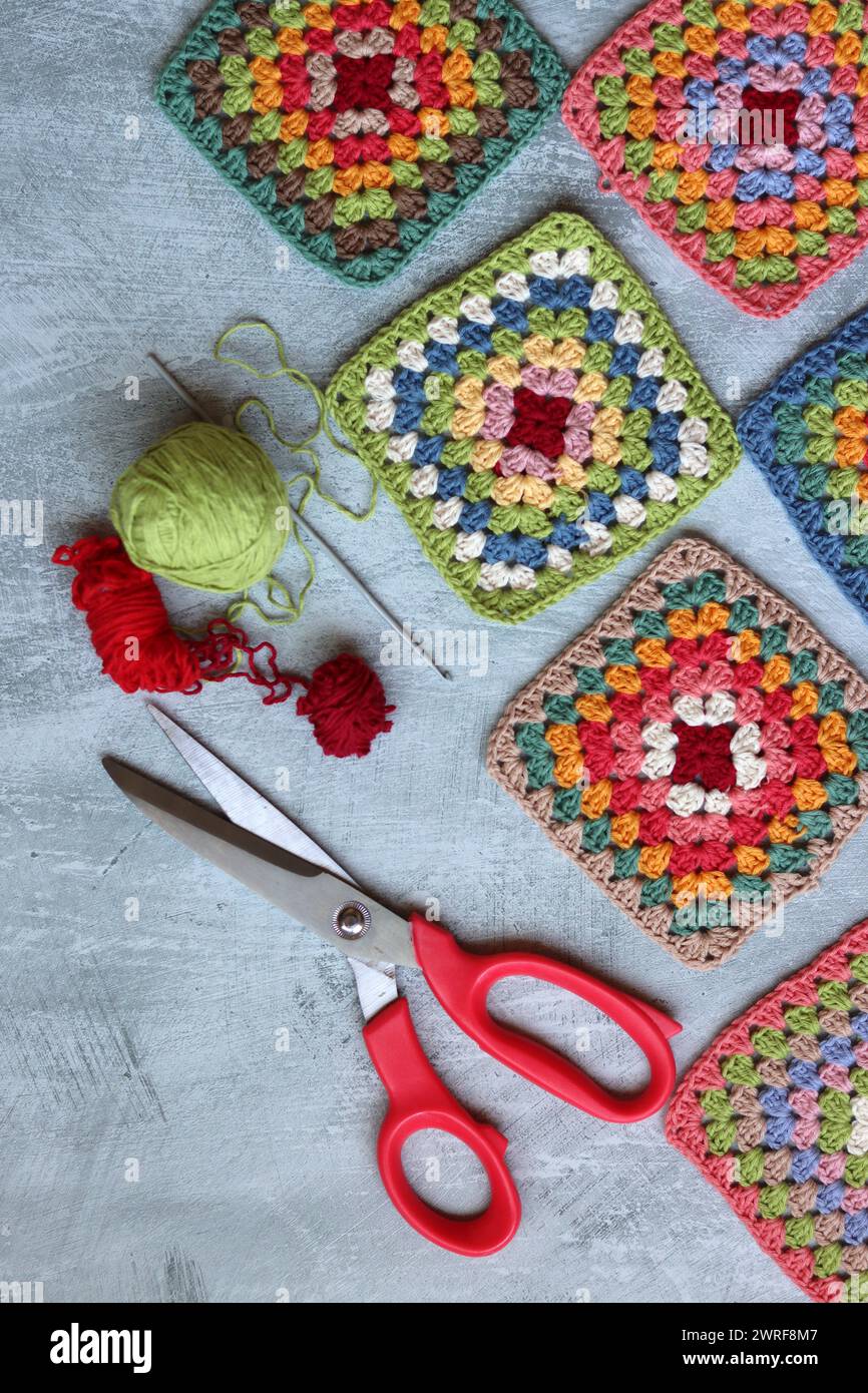 Handmade crocheting, needlework and handicraft concept. Rainbow colored ...