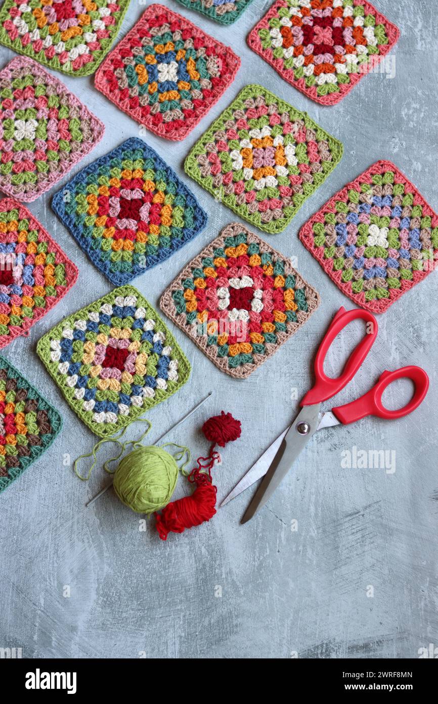 Handmade crocheting, needlework and handicraft concept. Rainbow colored ...
