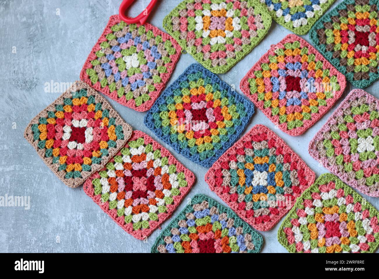 Handmade crocheting, needlework and handicraft concept. Rainbow colored ...