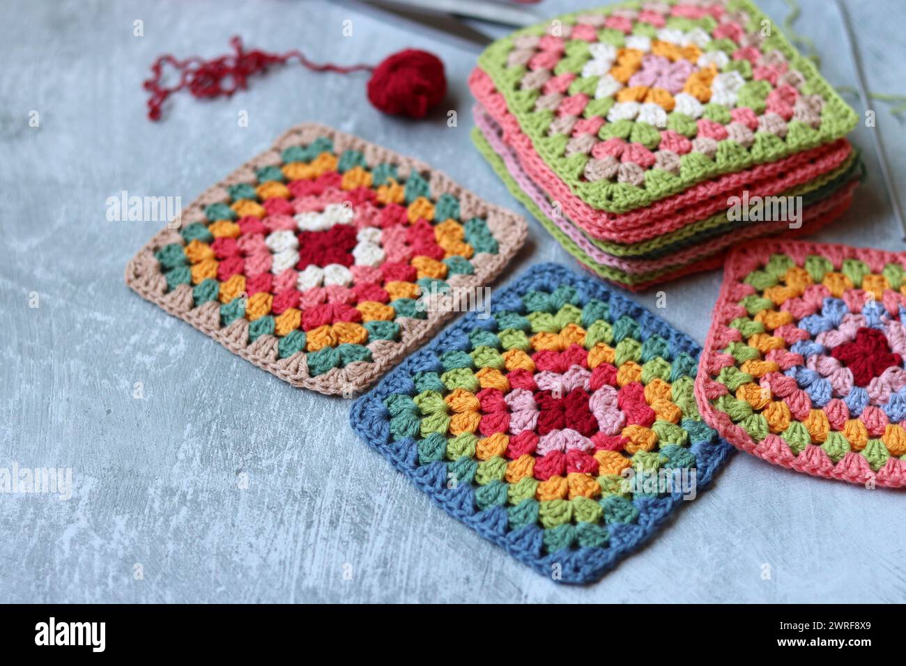Handmade crocheting, needlework and handicraft concept. Rainbow colored ...