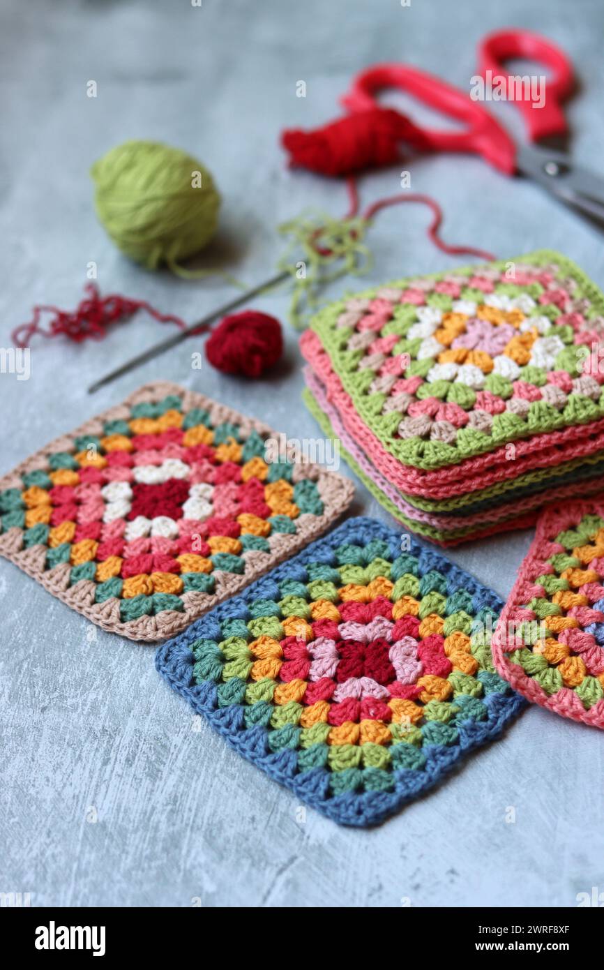Handmade crocheting, needlework and handicraft concept. Rainbow colored ...