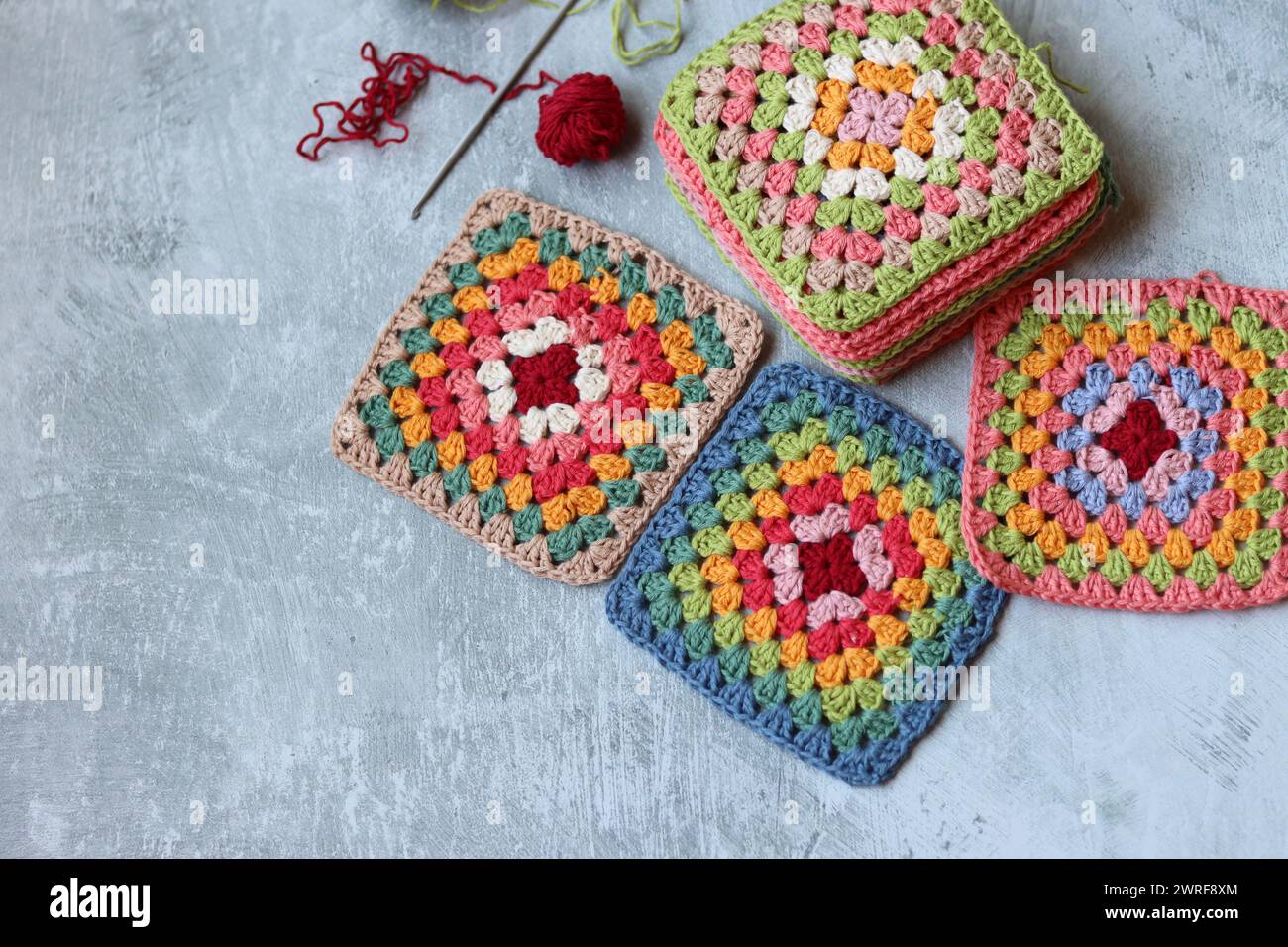 Handmade crocheting, needlework and handicraft concept. Rainbow colored ...