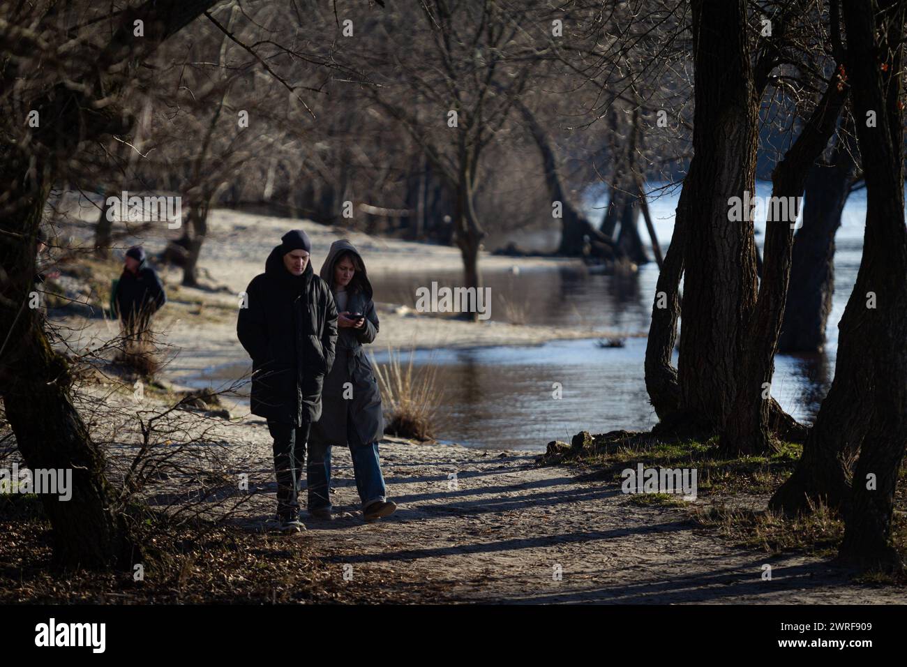 KYIV, UKRAINE - MARCH 11, 2023 - People walk by the Dnipro River where ...