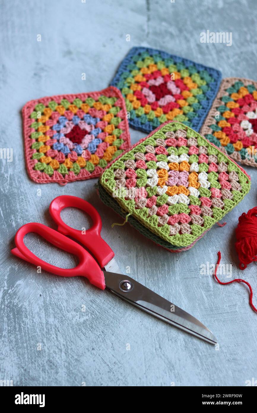 Handmade crocheting, needlework and handicraft concept. Rainbow colored ...