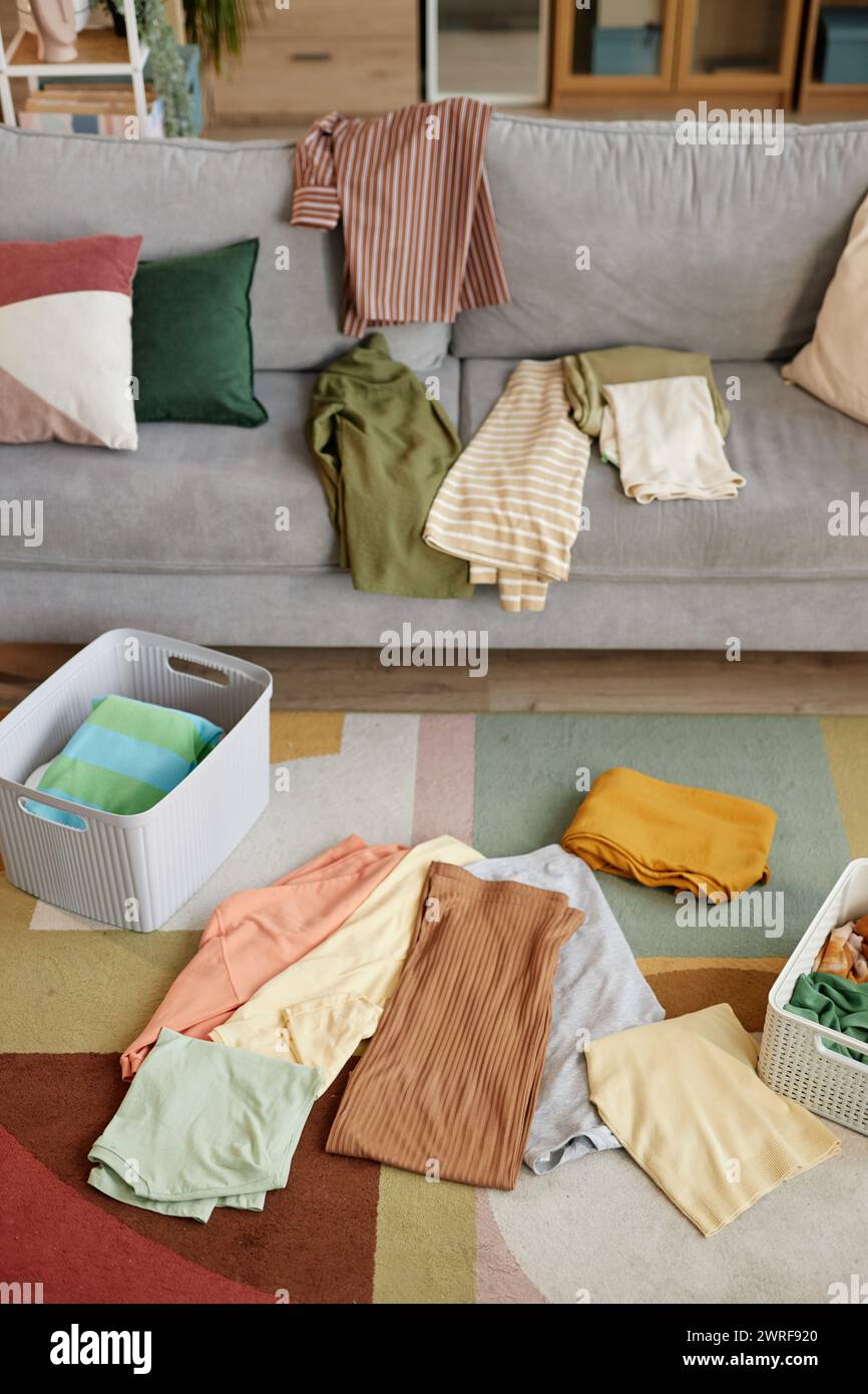 Background image of clean clothes sorted in stacks and storage boxes in ...