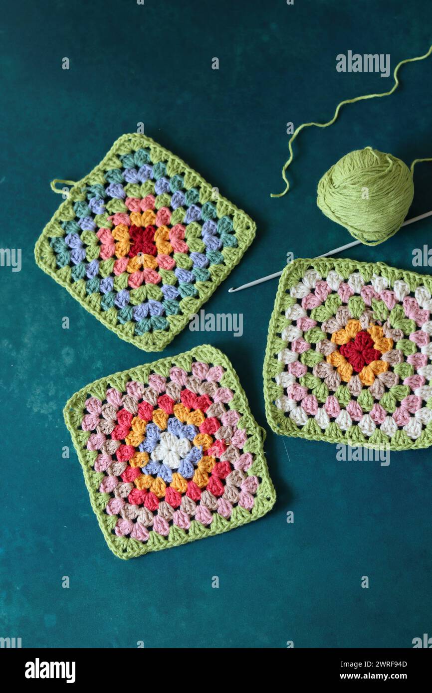 Handmade crocheting, needlework and handicraft concept. Rainbow colored ...