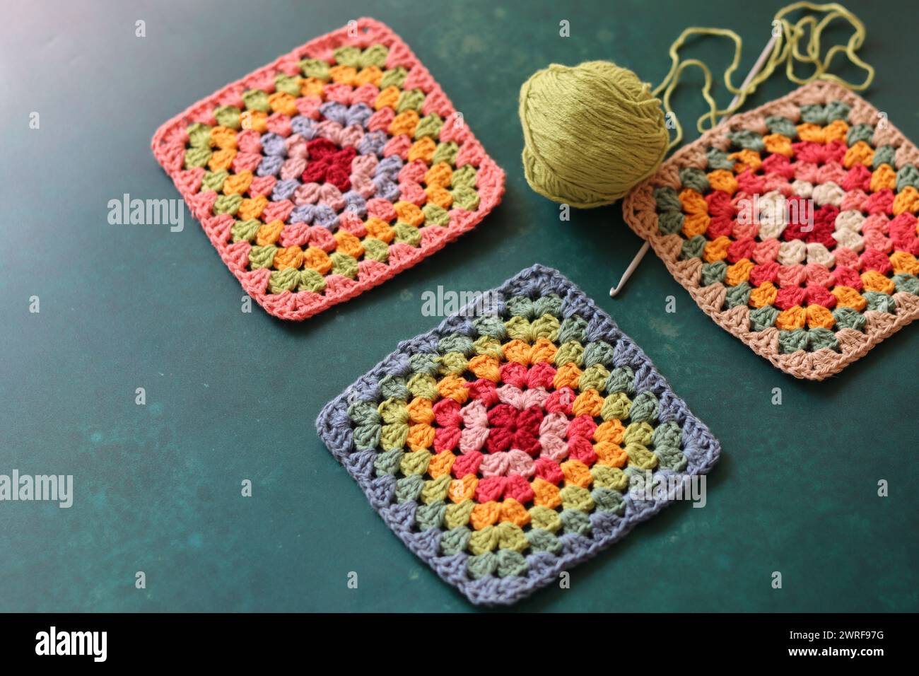 Handmade crocheting, needlework and handicraft concept. Rainbow colored ...
