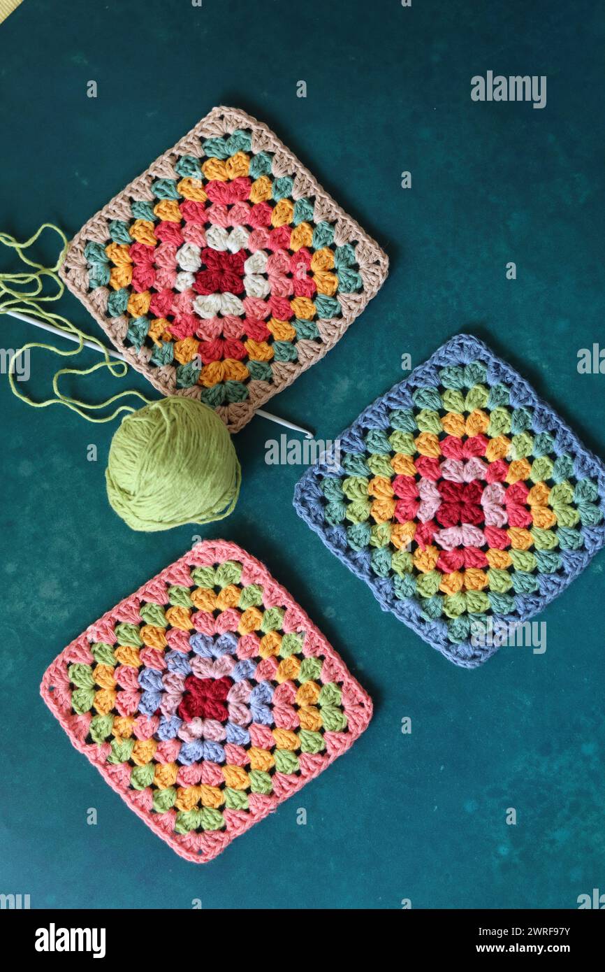 Handmade crocheting, needlework and handicraft concept. Rainbow colored ...