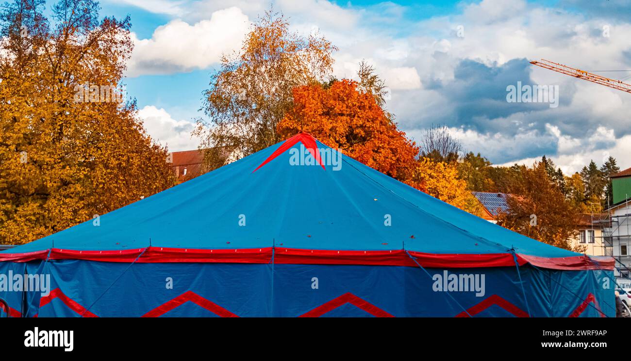 Autumn or indian summer view with a blue and red circus tent near ...