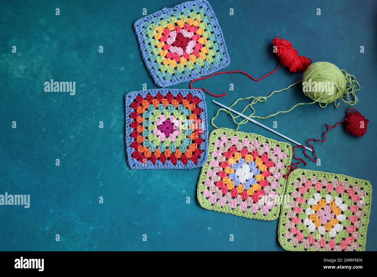Handmade crocheting, needlework and handicraft concept. Rainbow colored ...