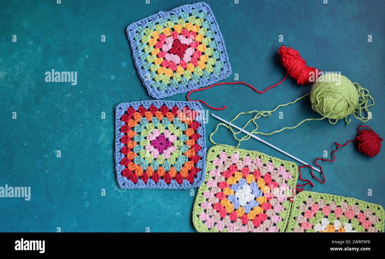 Handmade crocheting, needlework and handicraft concept. Rainbow colored ...