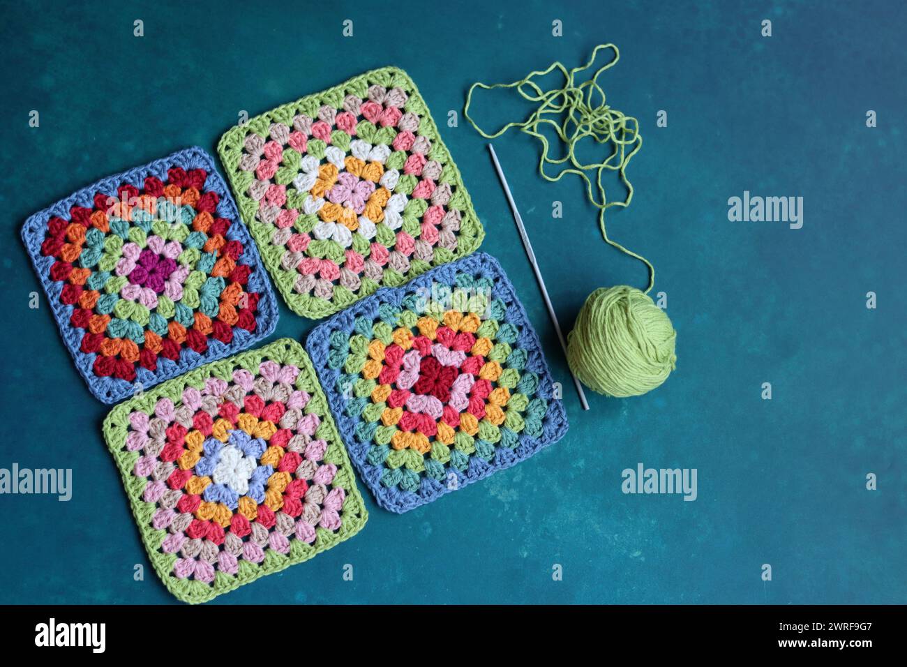 Handmade crocheting, needlework and handicraft concept. Rainbow colored ...