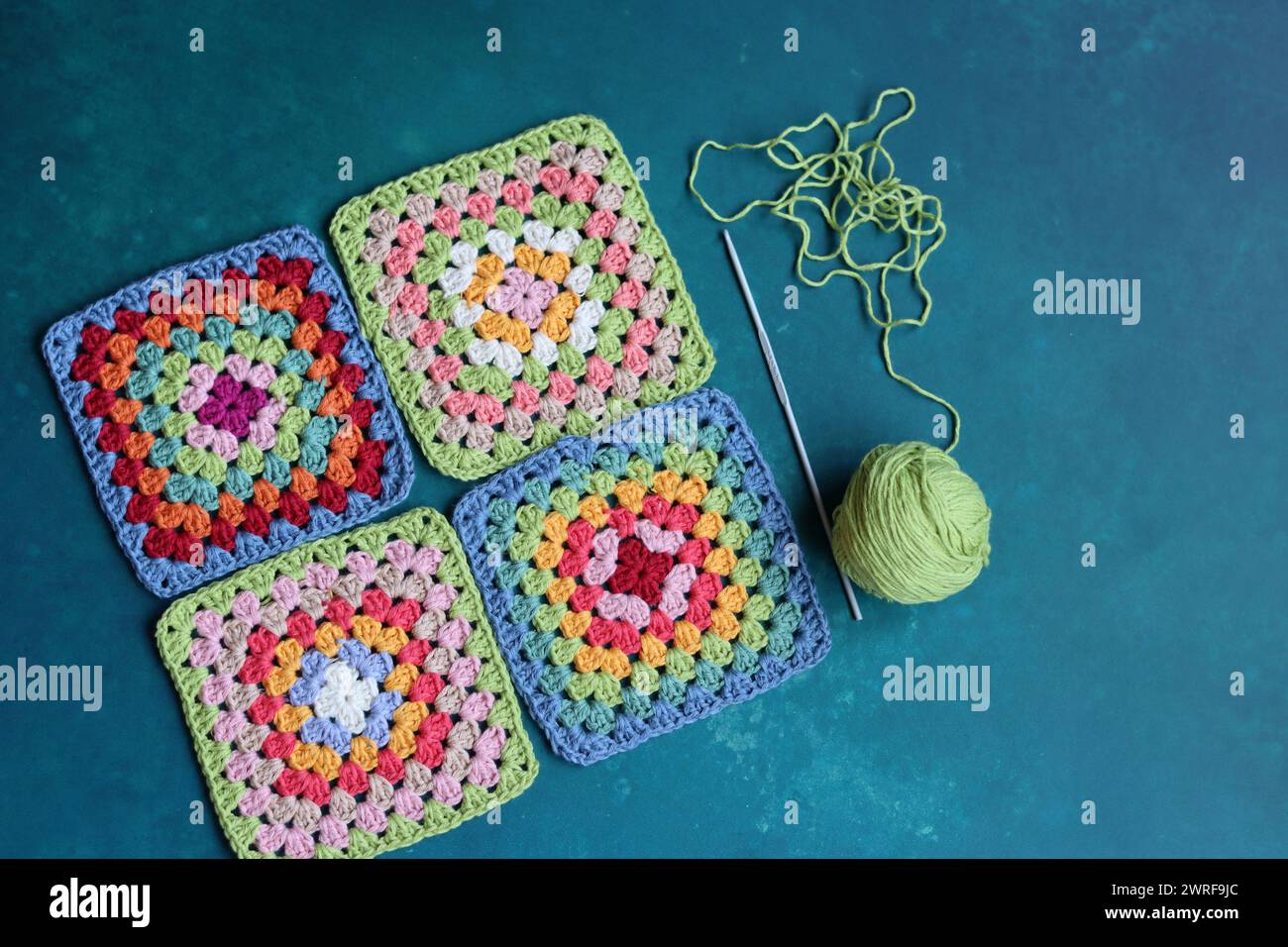 Handmade crocheting, needlework and handicraft concept. Rainbow colored ...