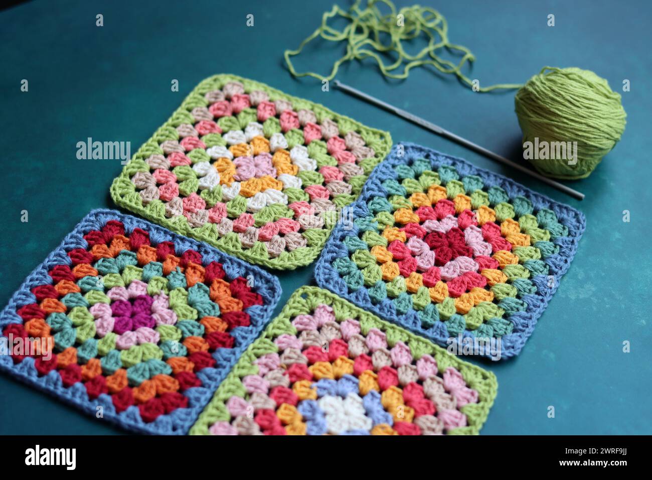 Handmade crocheting, needlework and handicraft concept. Rainbow colored ...