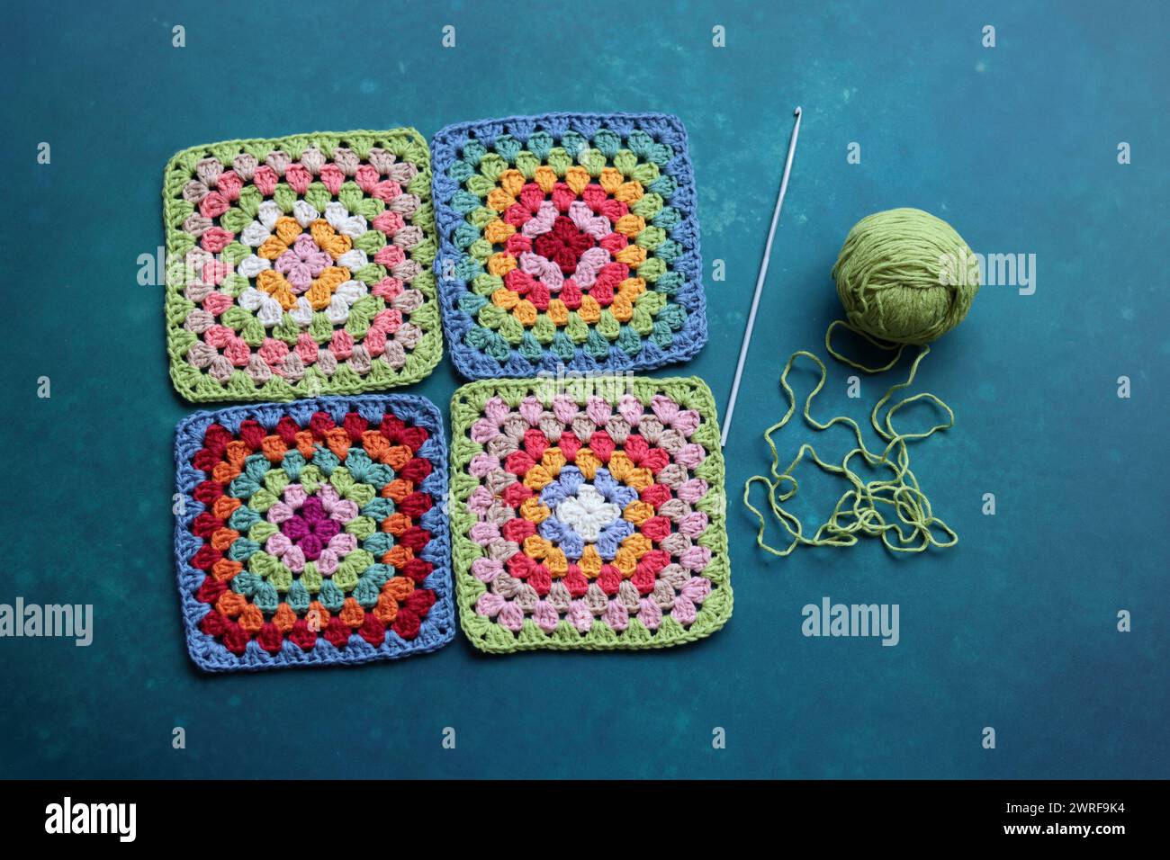 Handmade crocheting, needlework and handicraft concept. Rainbow colored ...