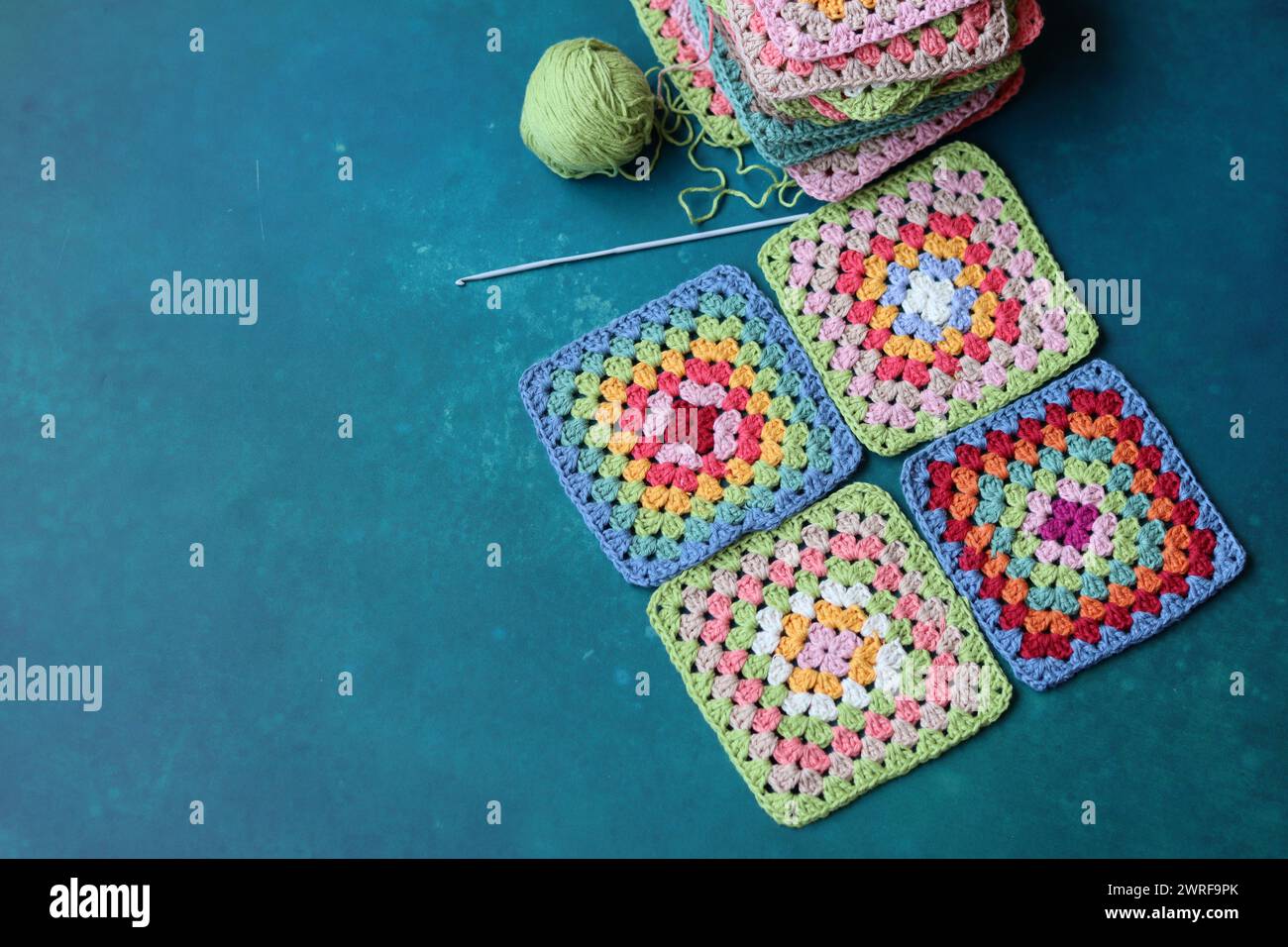 Handmade crocheting, needlework and handicraft concept. Rainbow colored ...