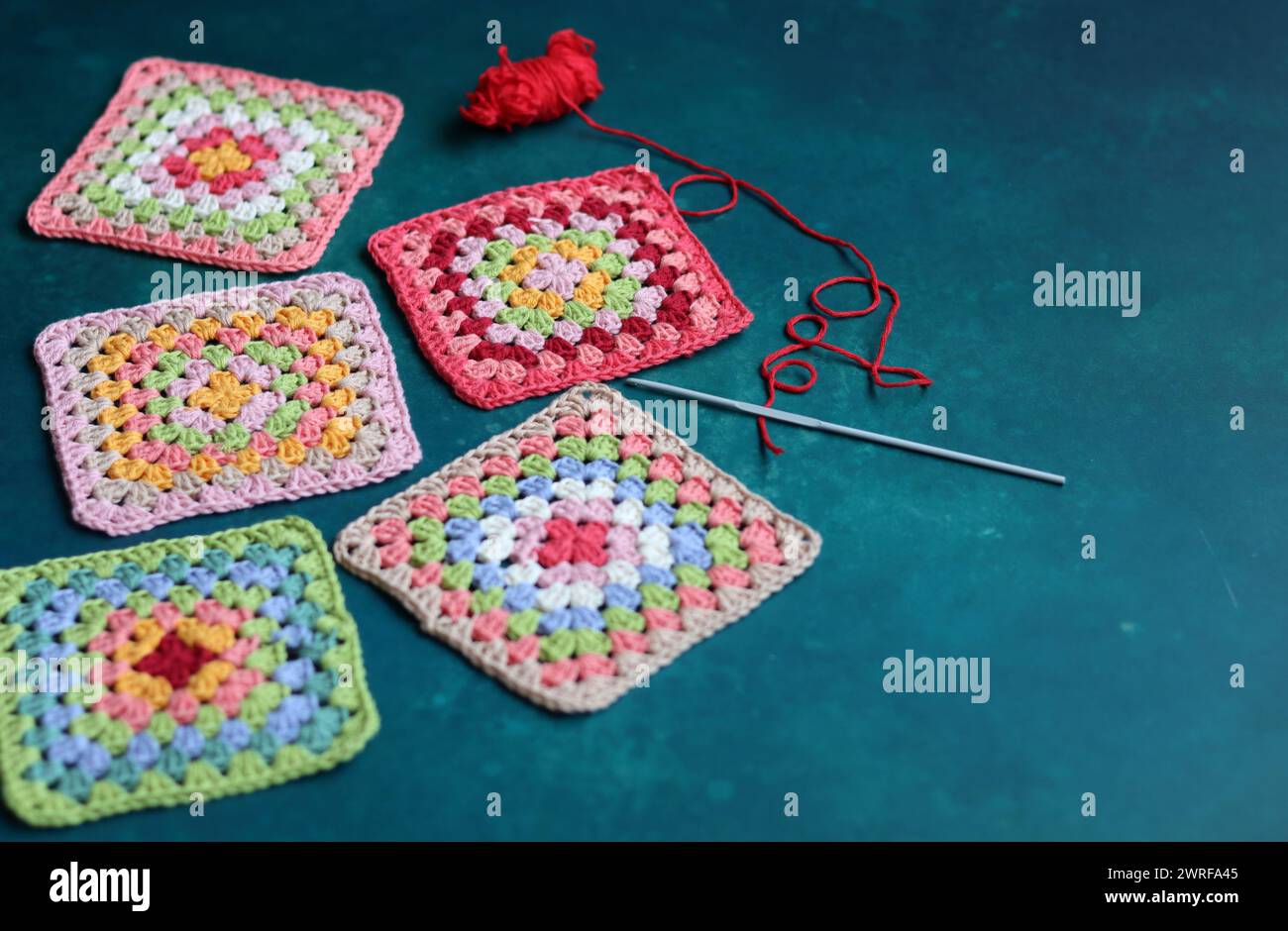 Handmade crocheting, needlework and handicraft concept. Rainbow colored ...
