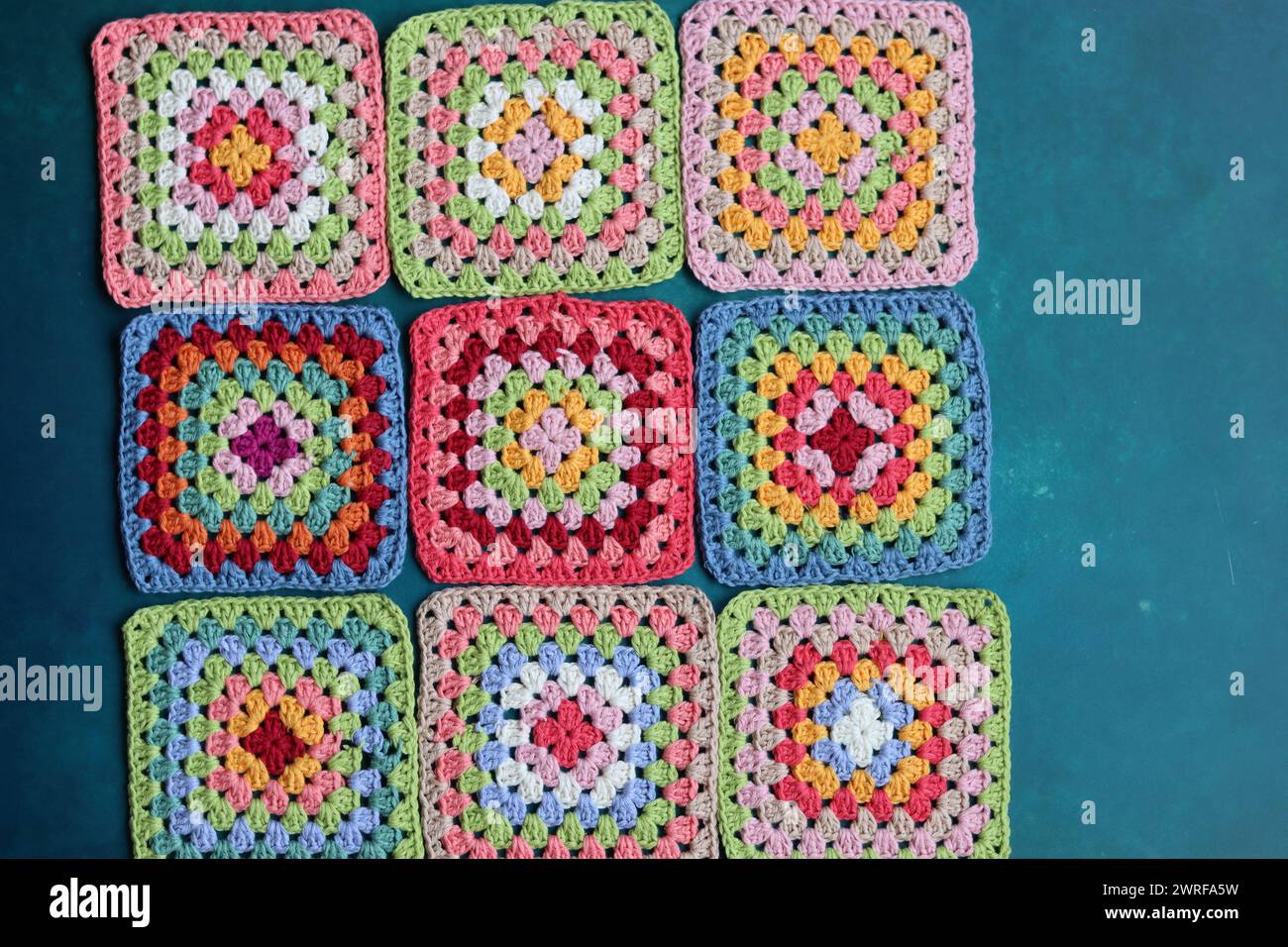 Handmade crocheting, needlework and handicraft concept. Rainbow colored ...