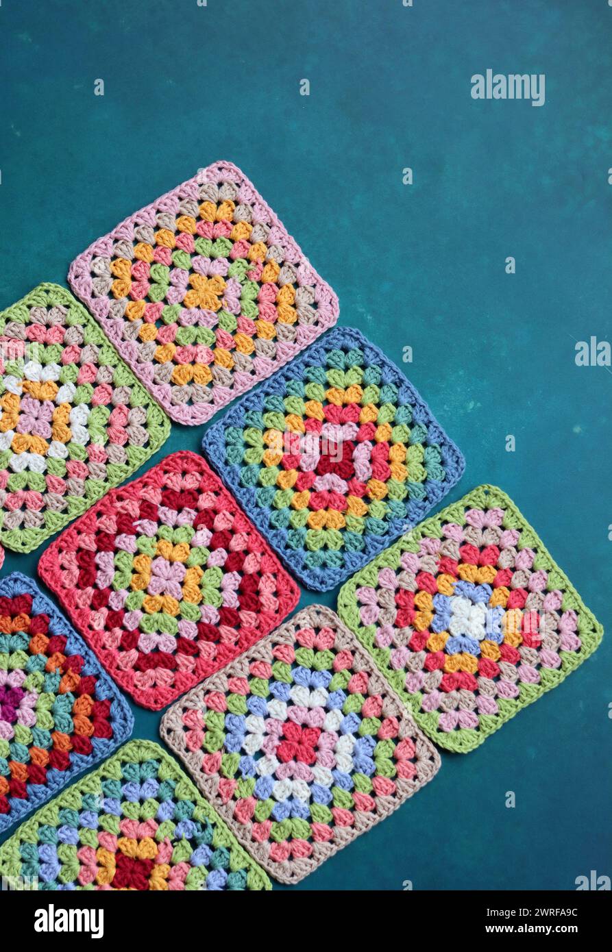 Crochet project in making. Colorful crochet squares close up photo ...