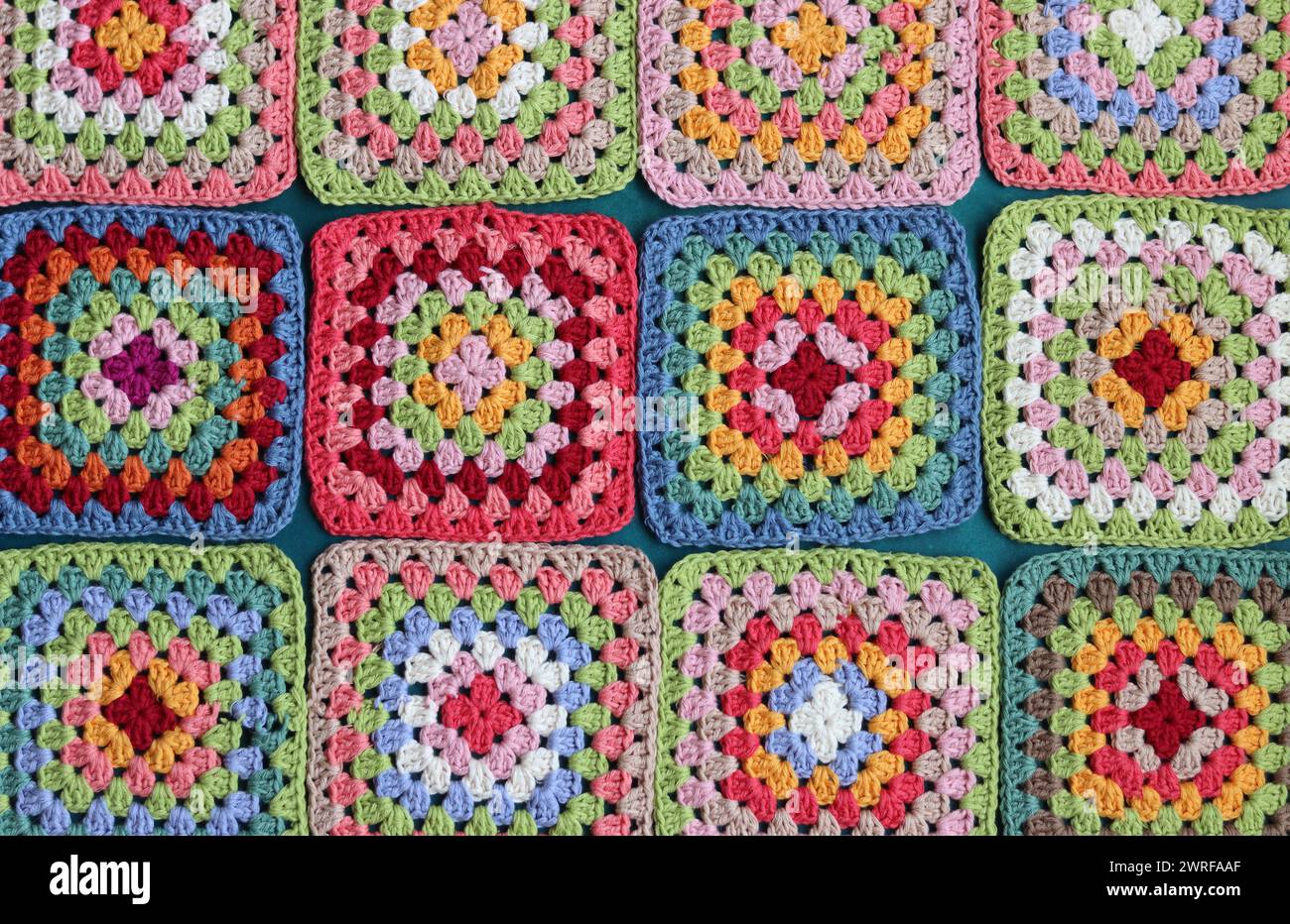 Handmade crocheting, needlework and handicraft concept. Rainbow colored ...