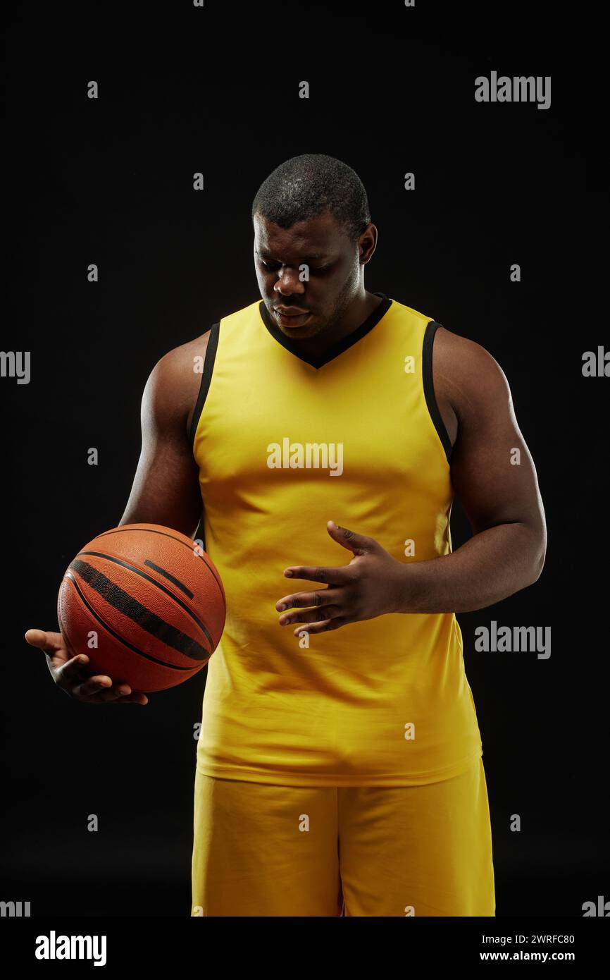 Vertical portrait of African American basketball player with ball ...