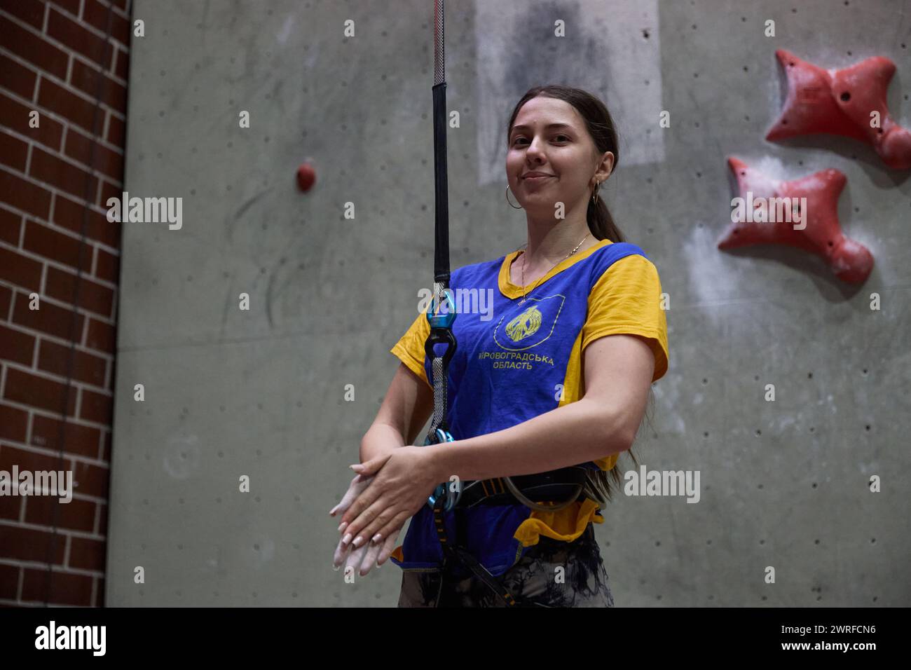 Young Ukrainian female climber posing with a smile while wearing a ...