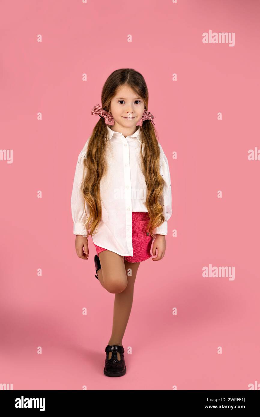 Full lenght photo with a little girl with long blond hair dressed in a ...