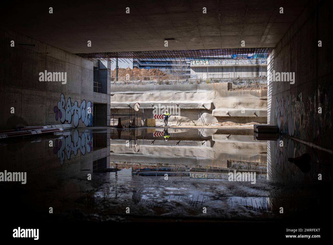 A worker works on the new phase of the central structure of the roof of ...