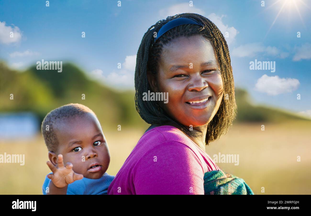 village african mother with braids carry child in the back wrapped in a ...