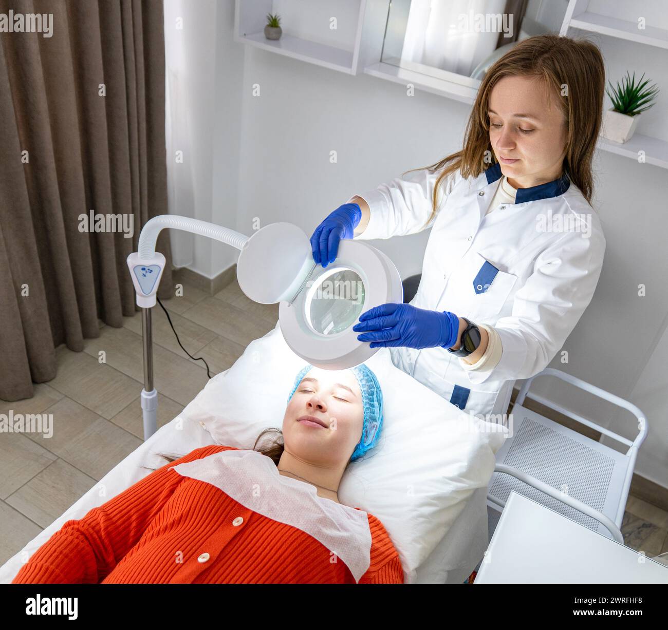 Healing skin problems. Beautician woman looking at client's face with ...