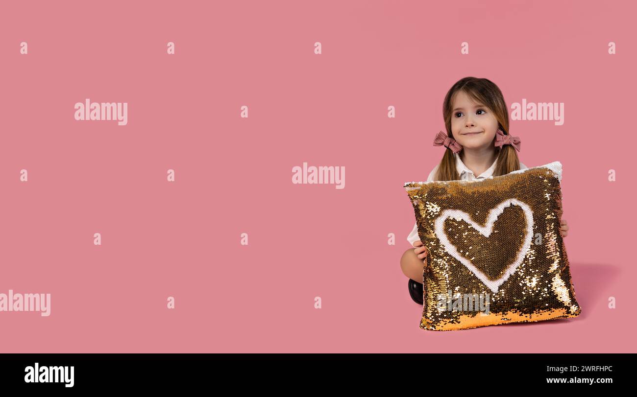 Stylish little girl looks to the side, isolated on pink background ...