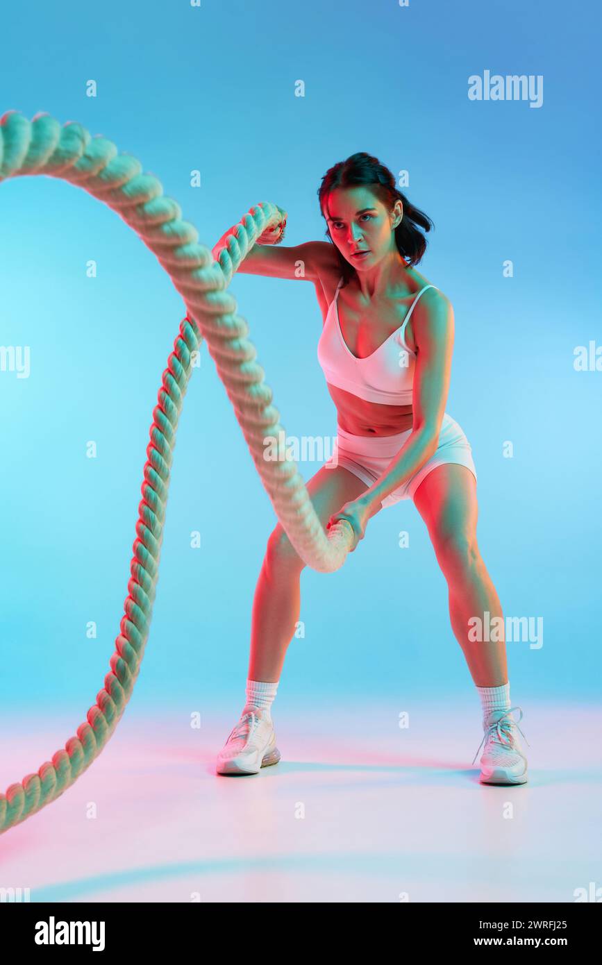 Sportive, slim young woman with strong muscular body training with ...