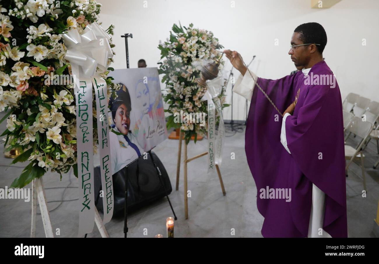 A priest swings incense in front of a photo of police officer Luciana ...