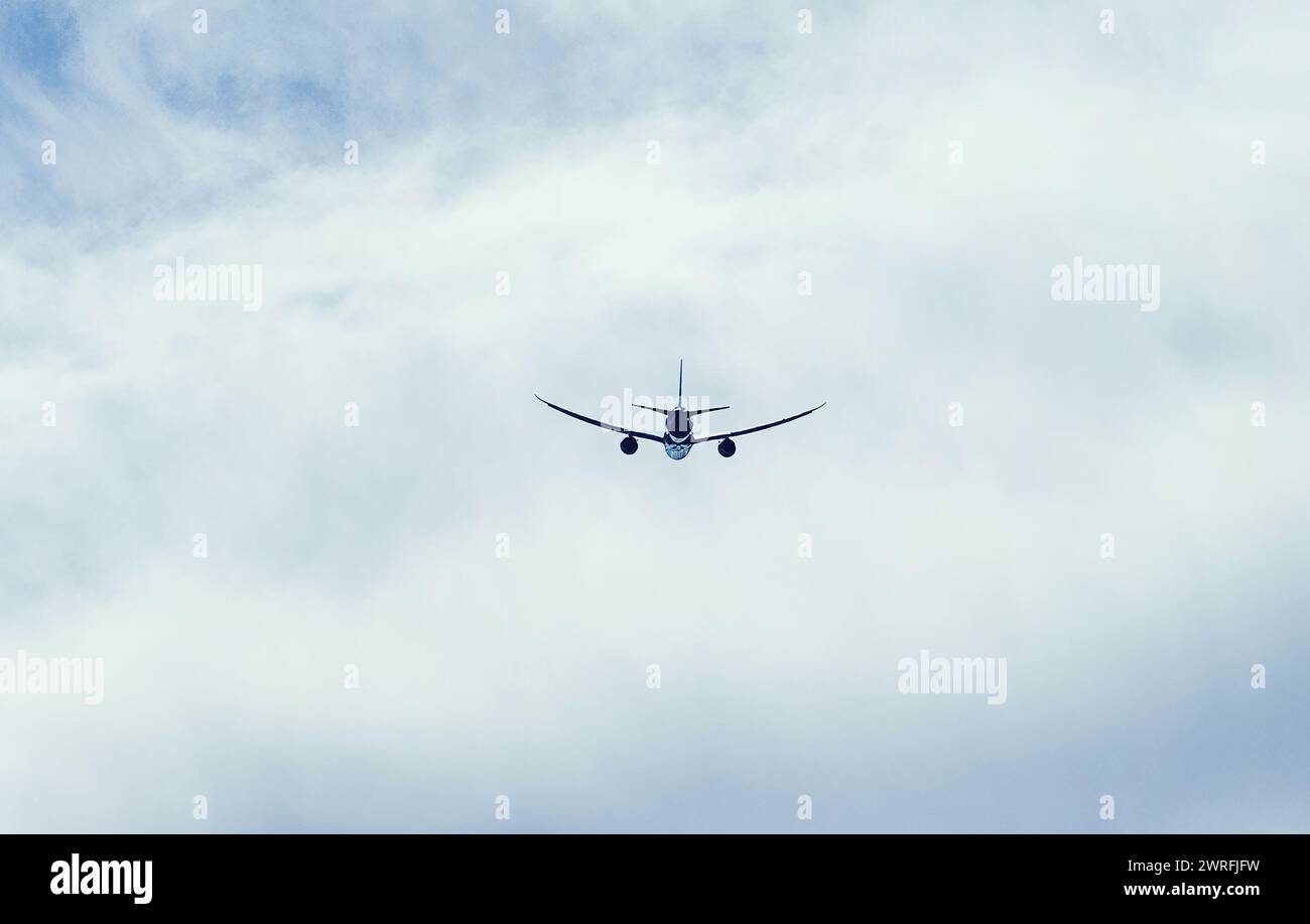 An airplane is soaring high above the ground, cutting through thick ...