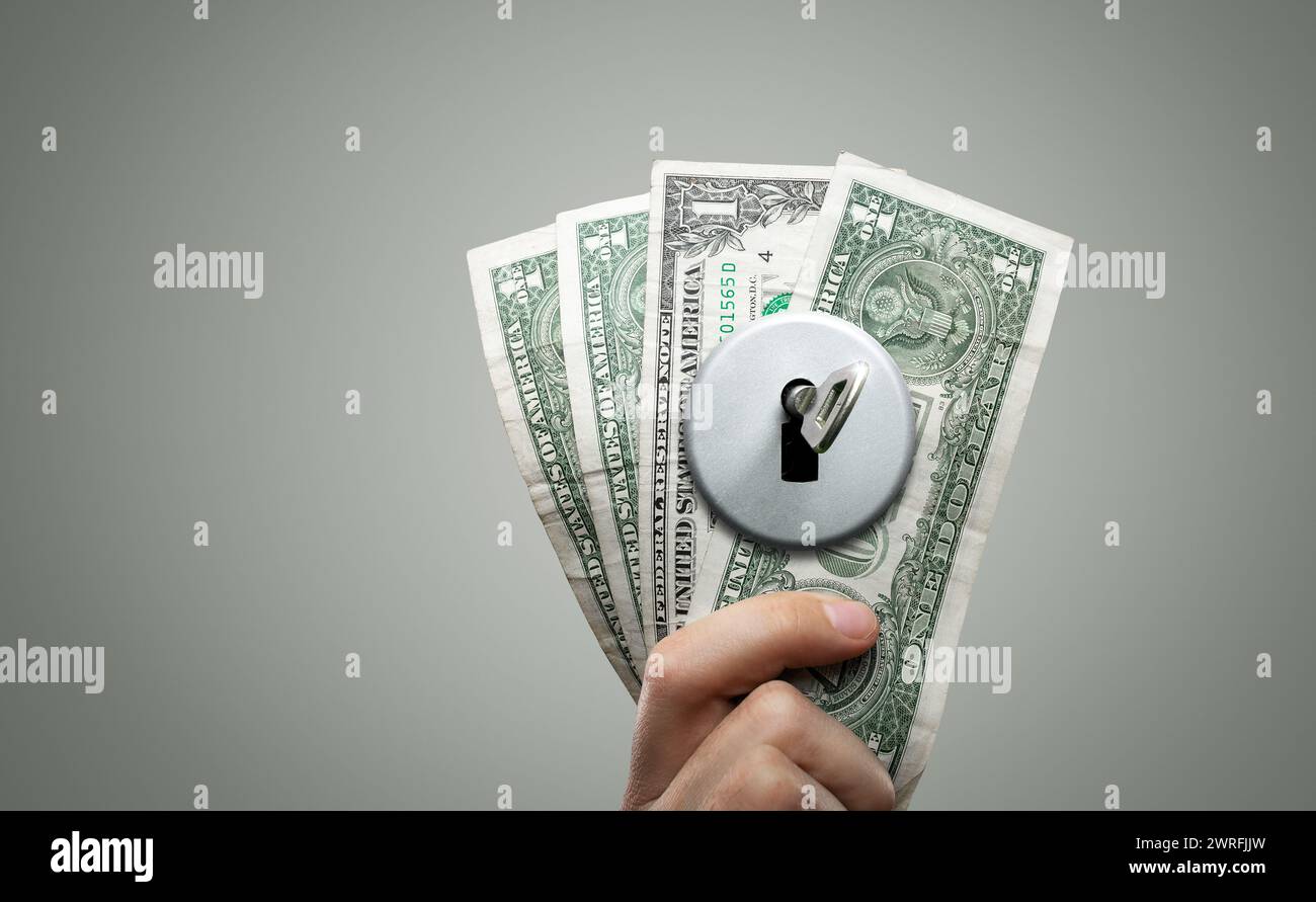 Key in a Lock on Dollar Bills - Financial Concept Stock Photo - Alamy