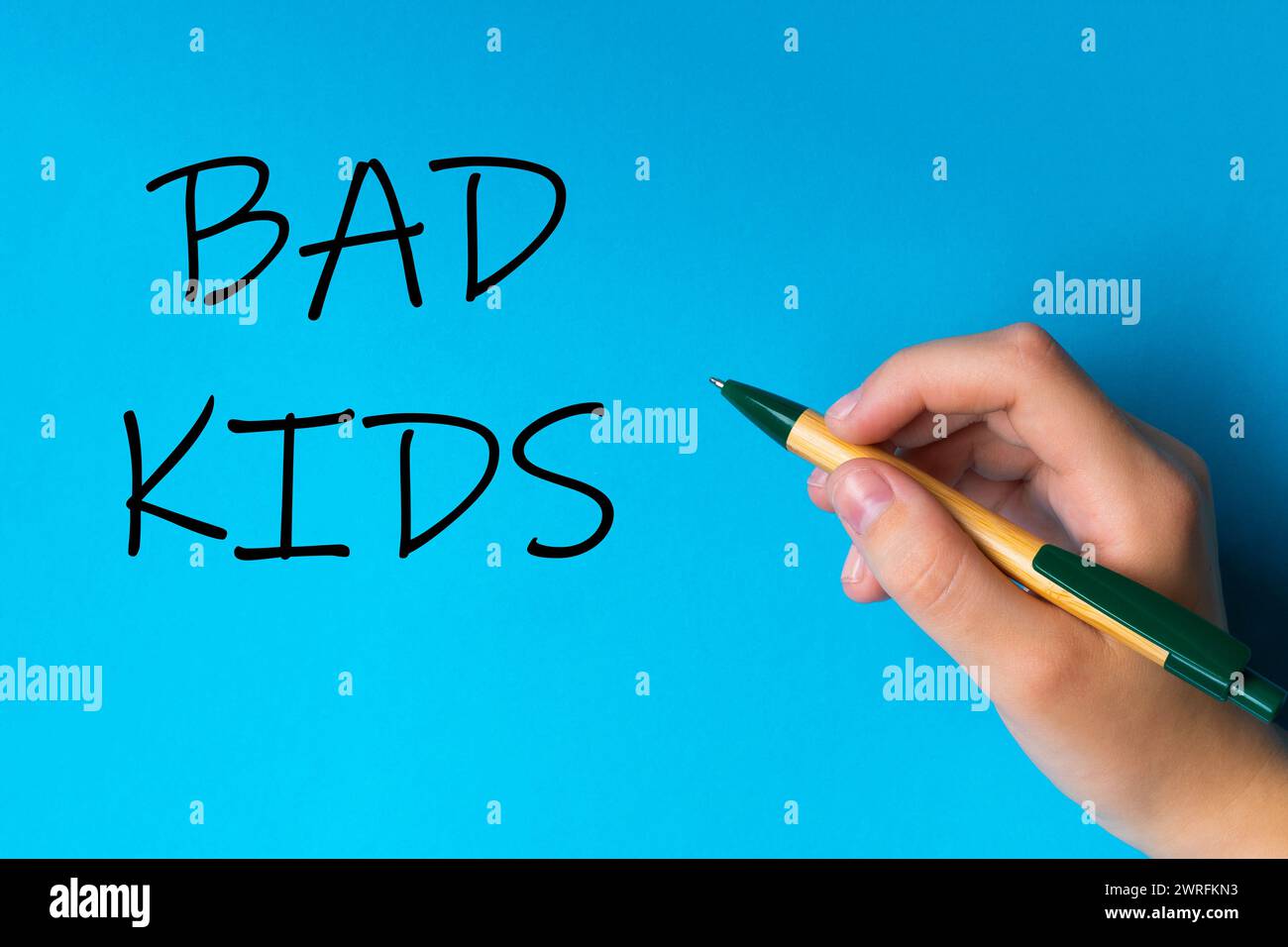 Children hand with pen write on an blue white background. Writing hand ...