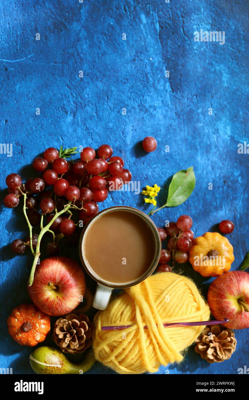 Cozy autumn still life with red apples and woolen yarn balls. Hobby and ...