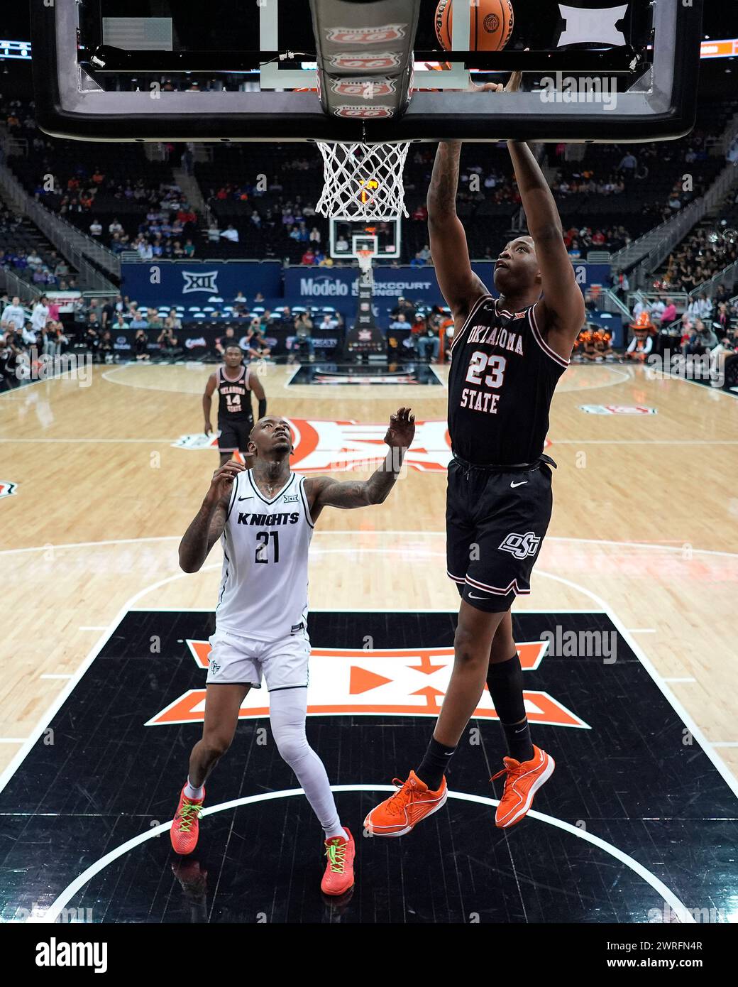 Oklahoma State center Brandon Garrison (23) gets past UCF forward C.J. Walker (21) to put up a ...