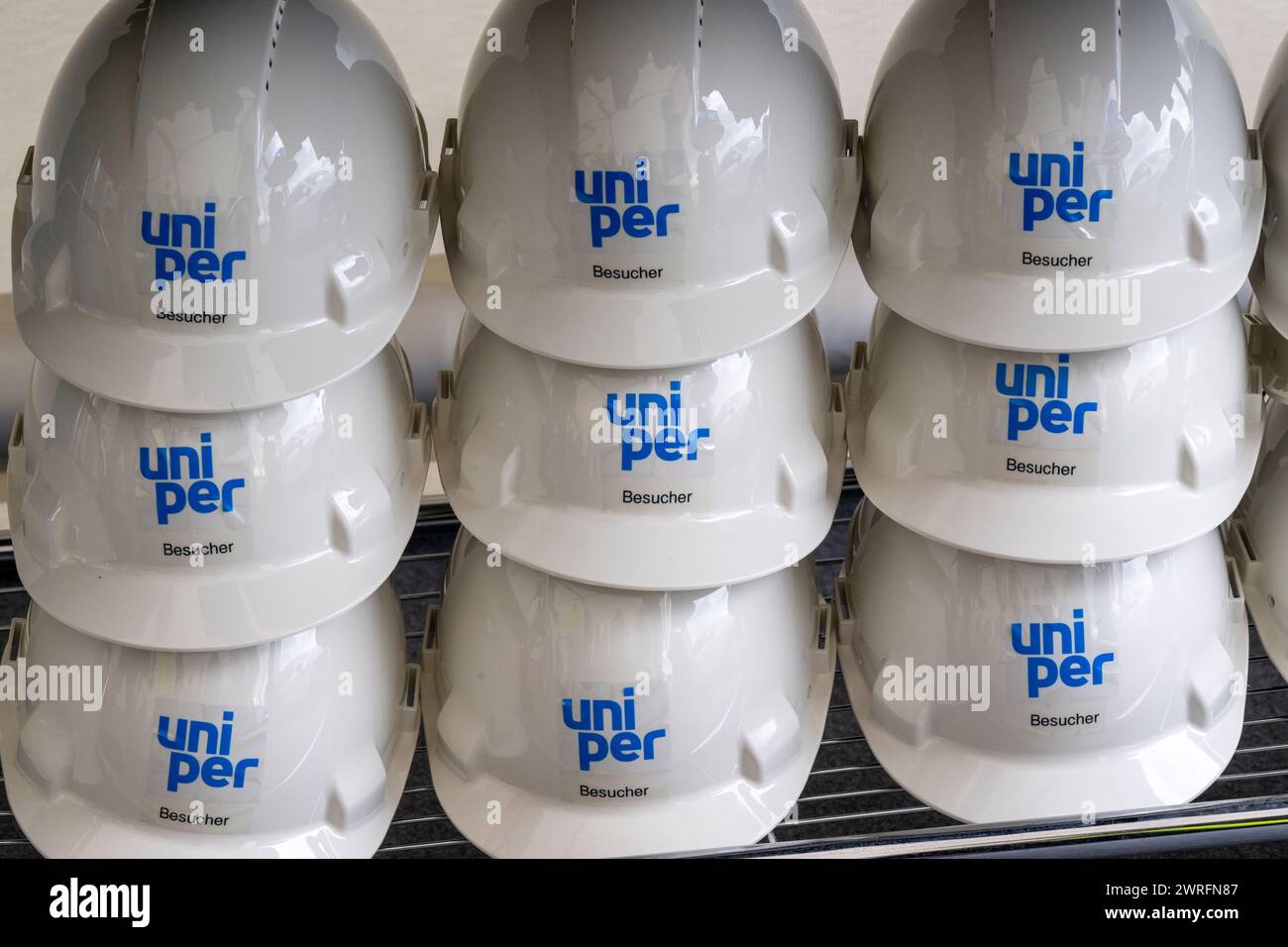 Unterreit, Germany. 12th Mar, 2024. Helmets labeled "Uniper" stand in a cupboard during the ...