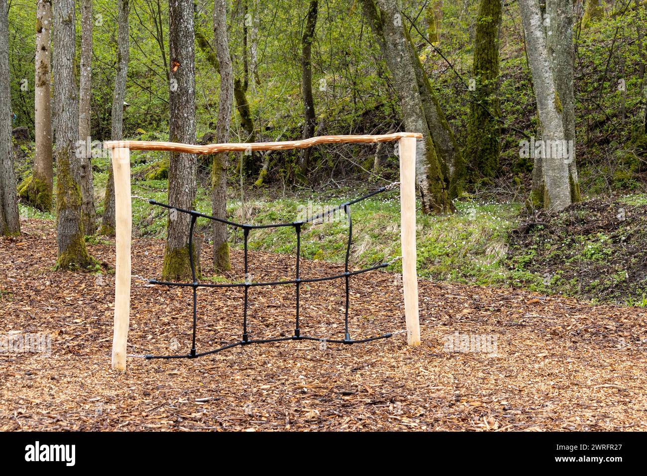 Wooden climbing frame with net in childrens outdoor playground Stock ...