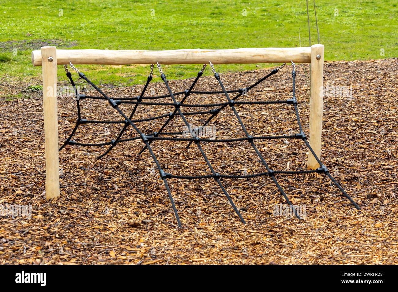 Wooden climbing frame with net in childrens outdoor playground Stock ...