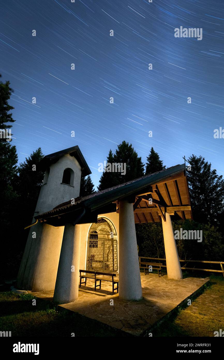 The alpine church of Regina Pacis on a starry night. Mount Zugna ...