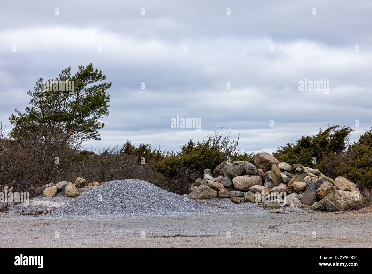 Two heaps of construction gravel and larger blocks of stone boulders ...