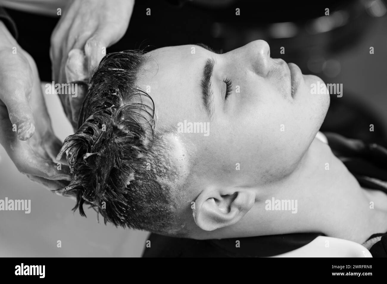 Barber shampooing washing a male client's head in the sink Stock Photo ...