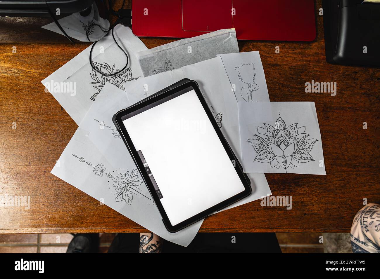 Horizontal photo an overhead view of an artist's desk, cluttered with ...