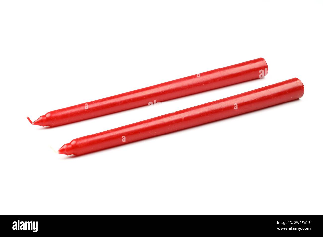 Red long candle isolated over white background Stock Photo - Alamy
