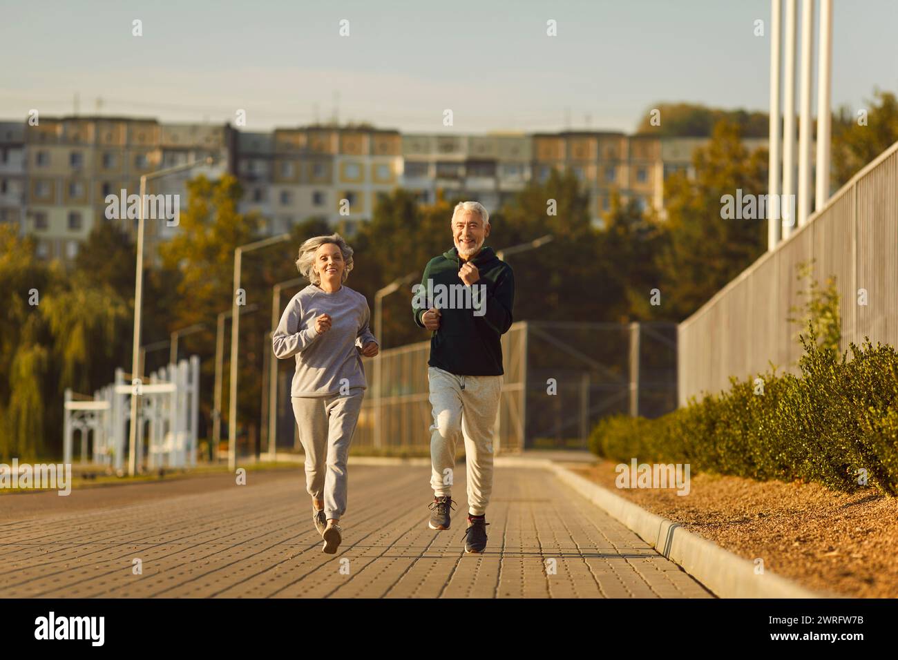 Active senior pair enjoy running, sporty physically energetic older man ...