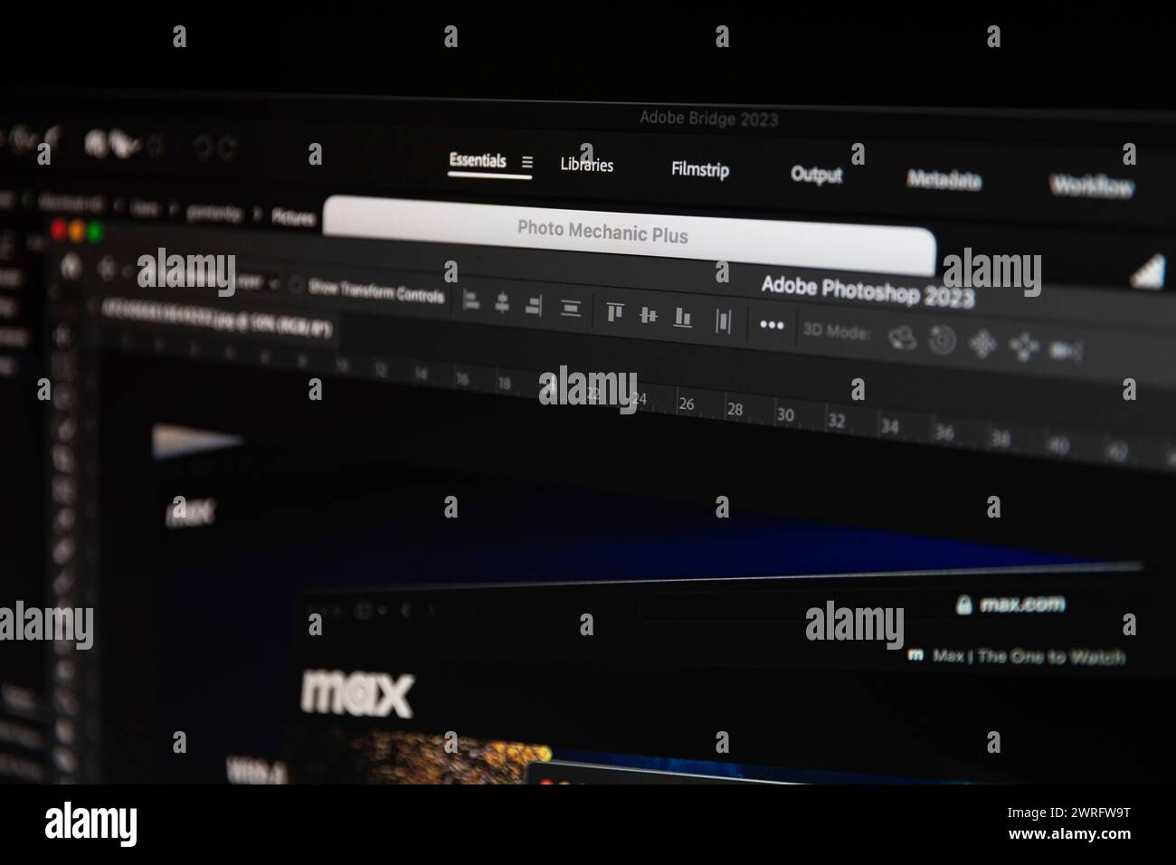 Adobe Photoshop, Lightroom and Bridge program windows are seen on a ...